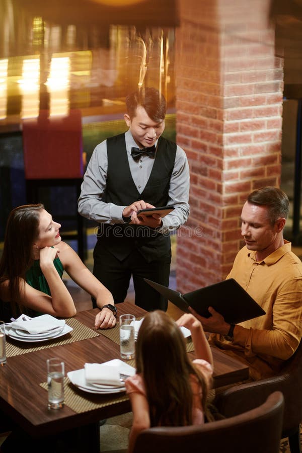 Waiter Accepting Order stock photo. Image of manu, talking - 260934126