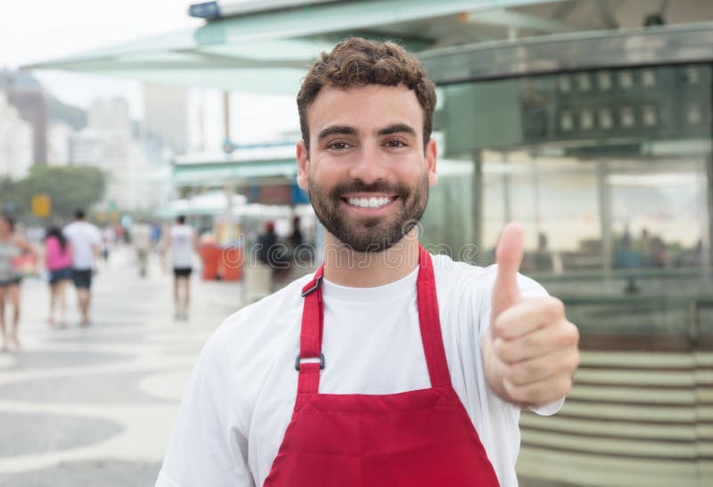 Waiter with Beard Showing Thumb in Front of a Restaurant Stock Photo ...