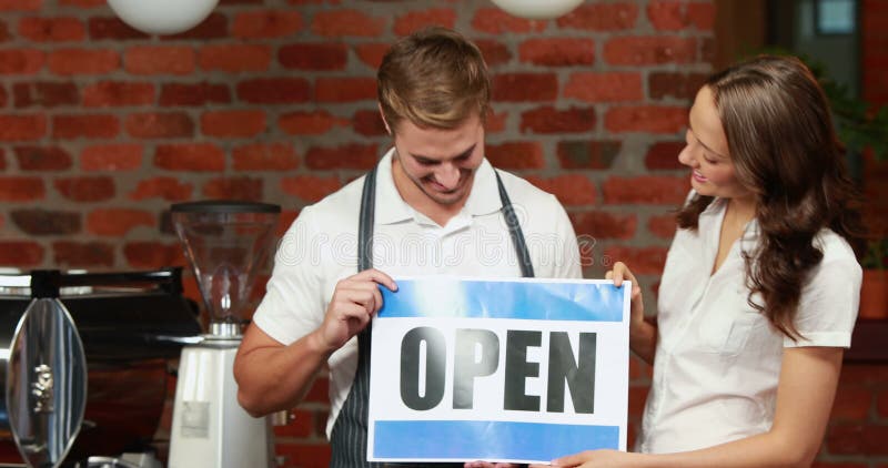 Waiter and Customer Holding a Board with Open Sign Stock Video - Video ...