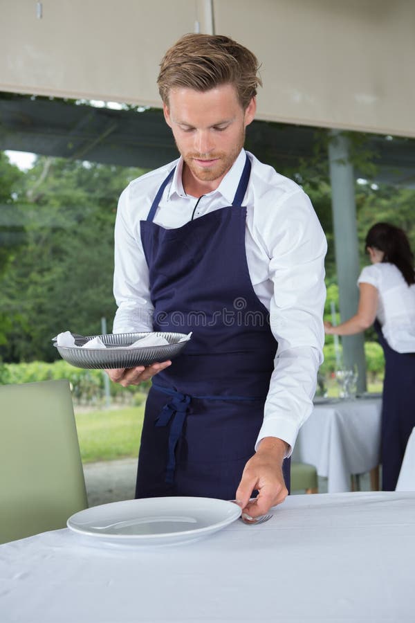 Waiter decorating table stock image. Image of arrangement - 100429107