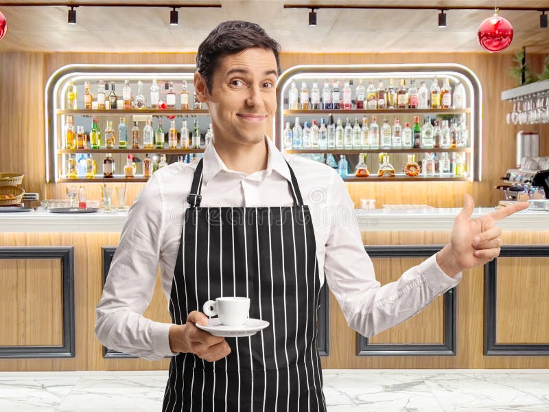 Waiter Holding Espresso Coffee and Pointing at a Bar Stock Photo ...