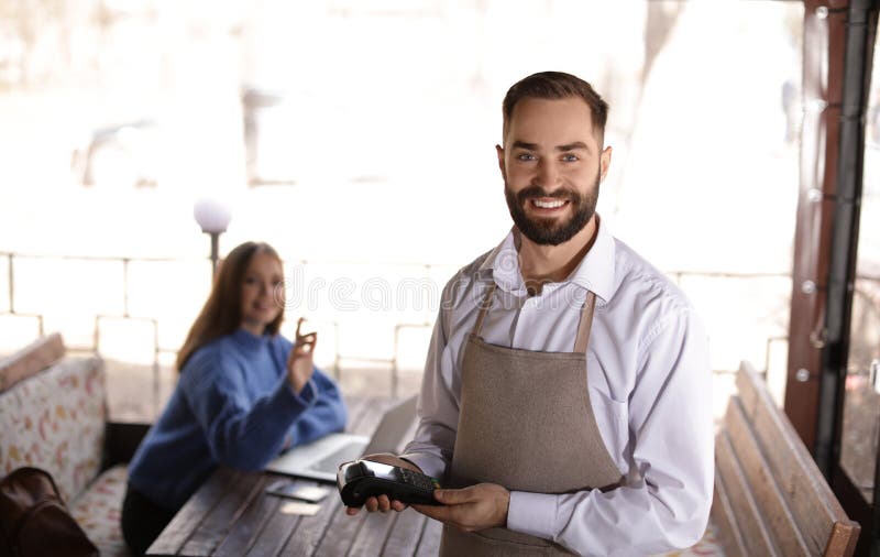 Waiter Holding Payment Terminal Near Table with Client Stock Image ...