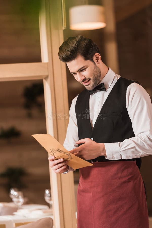 Waiter looking at menu stock photo. Image of wooden - 104984020