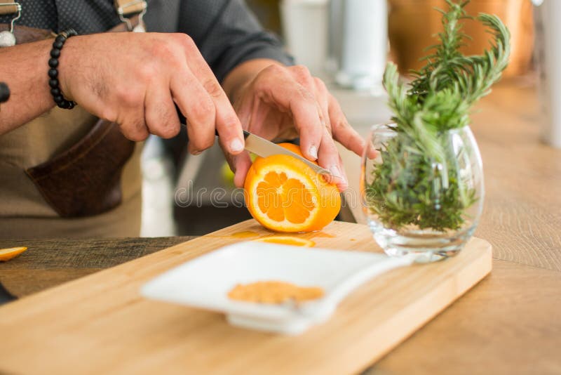 Waiter Preparing a Cocktail Cutting Orange Stock Image - Image of labor ...