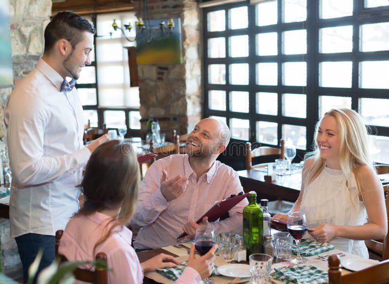 Waiter with Restaurant Guests at Table Stock Image - Image of plate ...
