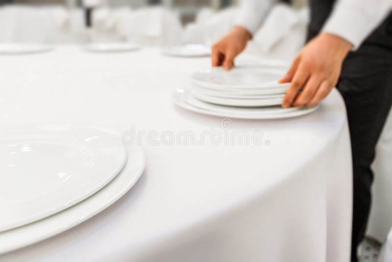 The Waiter in the Restaurant Serves the Dining Table. Close Up ...