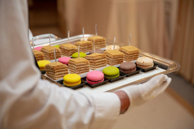 The Waiter Serves an Expensive Dessert of Macaroons. Macaroon in the ...