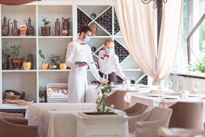 The Waiter Serves a Table in a Cafe in a Protective Mask Stock Photo ...
