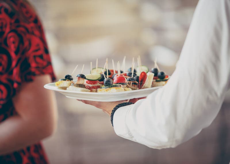Waiter serving appetizers stock image. Image of dinner - 60112281