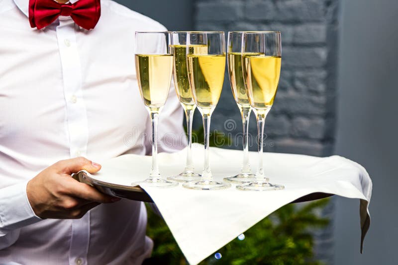 Waiter Serving Champagne Glasses on a Tray in a Restaurant Stock Image ...