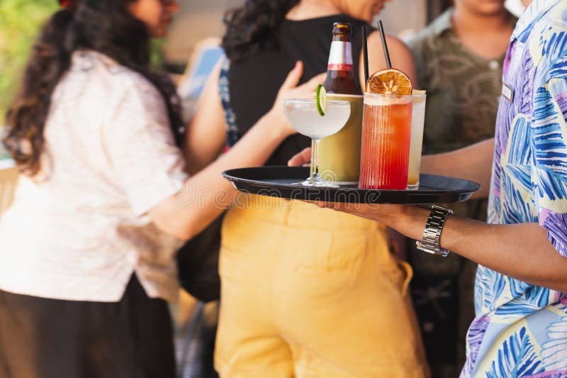 Waiter Serving Cocktail for Group of People Celebrating. Stock Image ...