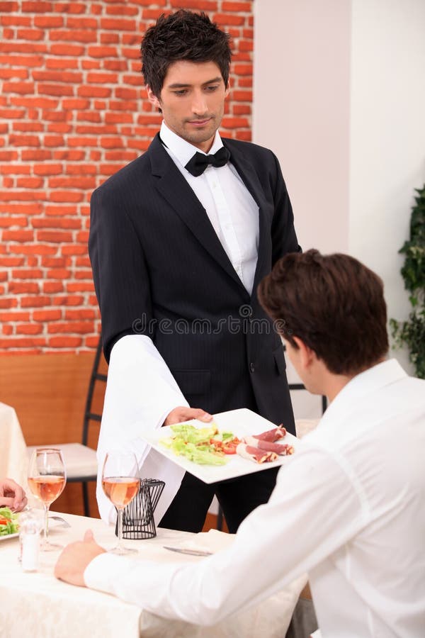 Waiter serving a meal stock image. Image of dish, person - 35741259