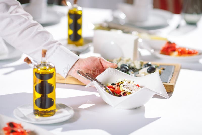 Waiter Serving Table in the Restaurant Preparing To Receive Guests ...
