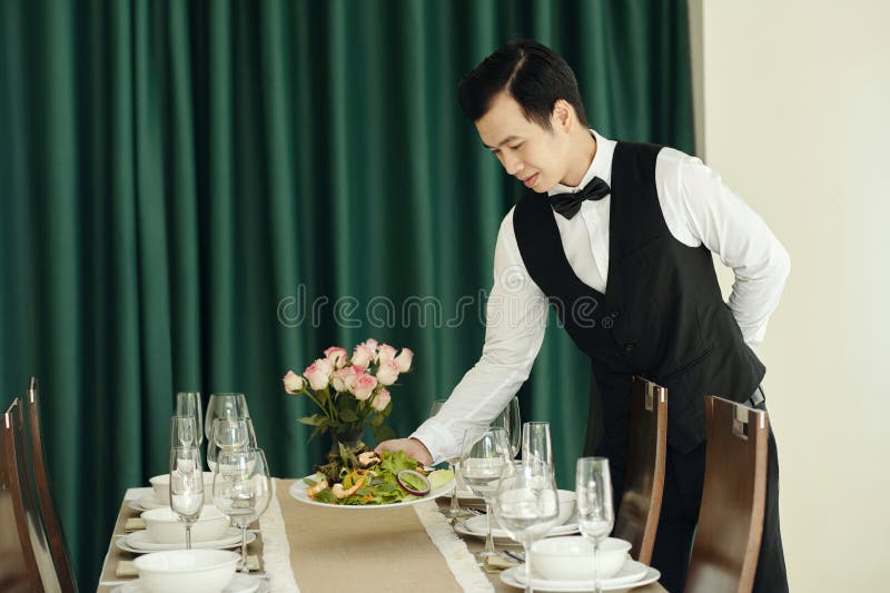 Waiter Setting Dish on Dining Table Stock Image - Image of waiter ...
