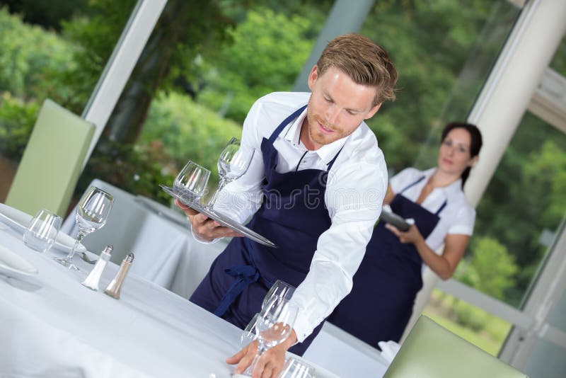 Waiter setting up table stock photo. Image of modern - 150568422