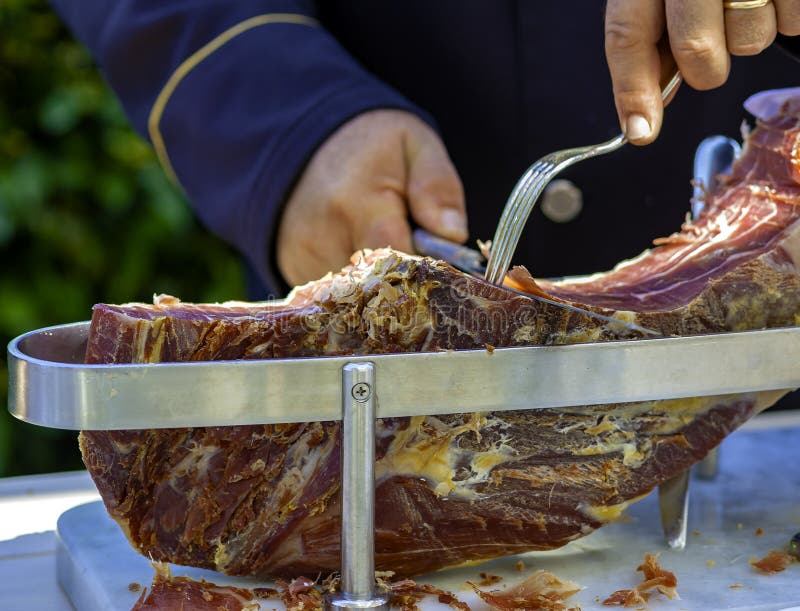 Waiter is slicing raw ham stock photo. Image of jamon - 128064872