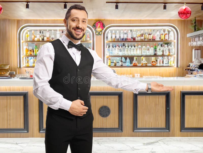 Waiter Smiling and Gesturing Welcome Stock Image - Image of single ...