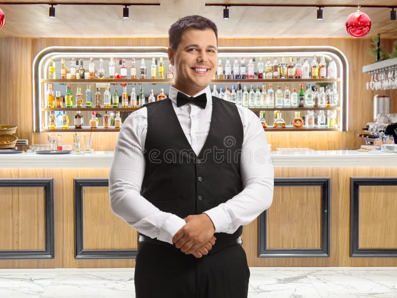 Waiter Smiling and Posing in Front of a Hotel Bar Stock Photo - Image ...
