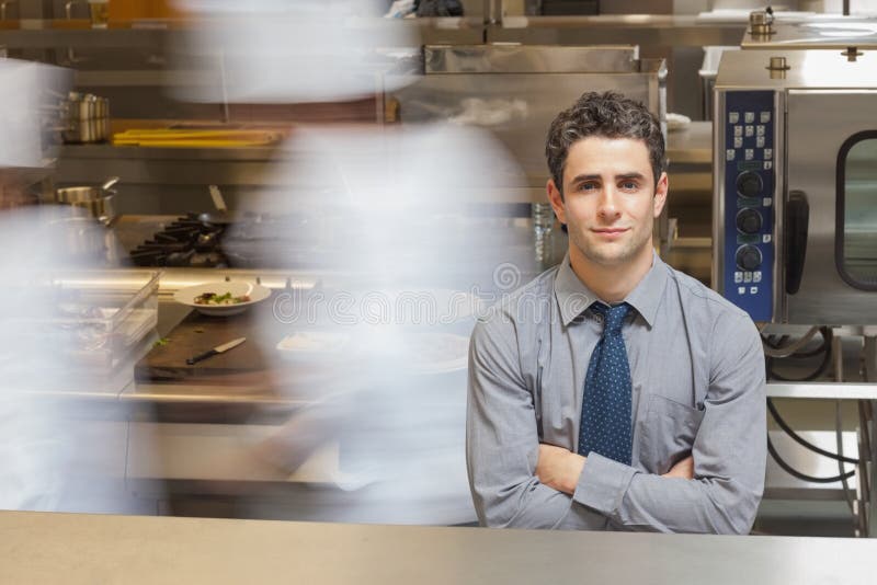 Waiter Standing in Busy Kitchen Stock Image - Image of uniform ...