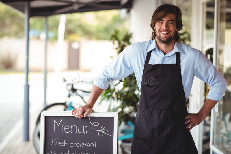 Waiter Standing with Menu Board Outside the Cafe Stock Photo - Image of ...
