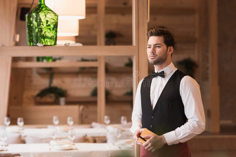 Waiter Standing with Notebook and Pen Stock Photo - Image of restaurant ...