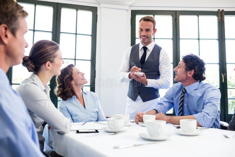 Waiter taking an order stock image. Image of adult, digital - 68262739