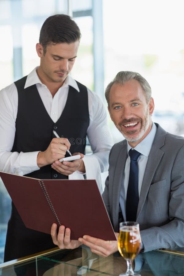 Waiter Taking the Order from a Businessman Stock Photo - Image of ...