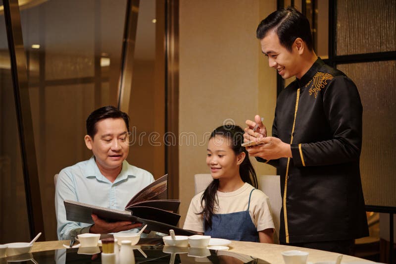 Waiter Talking To Guests in the Restaurants Stock Photo - Image of ... Waiter Talking To Guests in the Restaurants Stock Photo - Image of ...