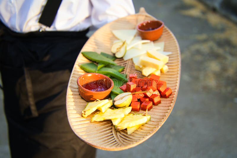 Waiter with Tray with Different Types of Gourmet Cheeses with Two Bowls ...