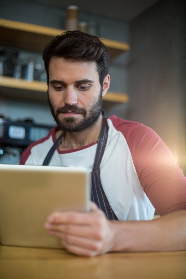 Waiter Using Digital Tablet at Counter Stock Photo - Image of digital ...
