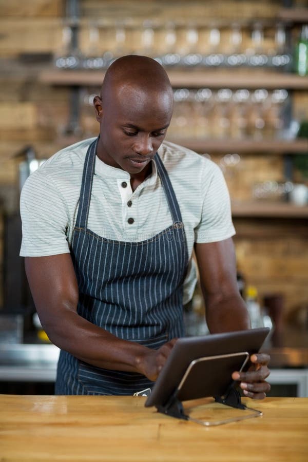 Waiter Using Digital Tablet at Counter Stock Image - Image of expertise ...