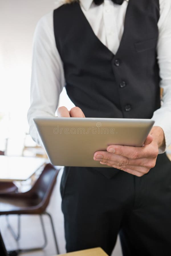 Waiter Using Digital Tablet in Restaurant Stock Image - Image of ...
