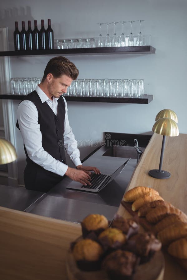 Waiter Using Laptop at Counter Stock Photo - Image of profession ...