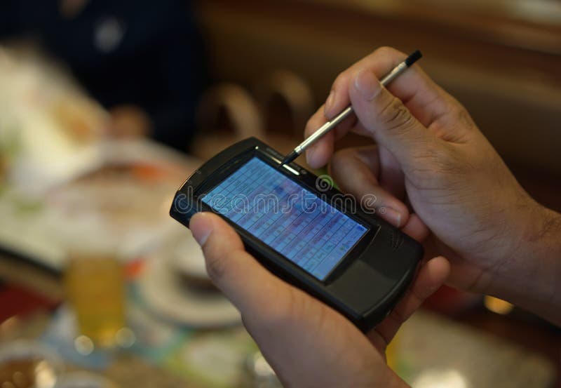 A Waiter Using a PC Pocket, PDA Technology Stock Image - Image of meal ...