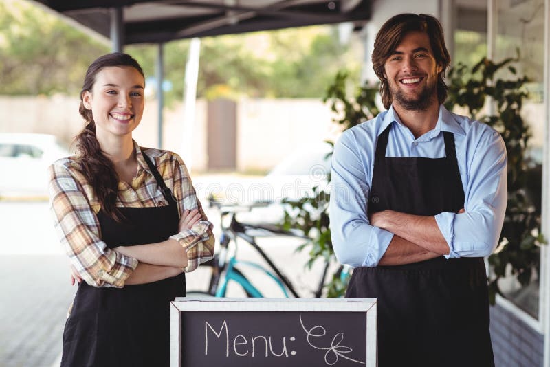 Waiter and Waitress Standing with Menu Board Outside the Cafe Stock ...