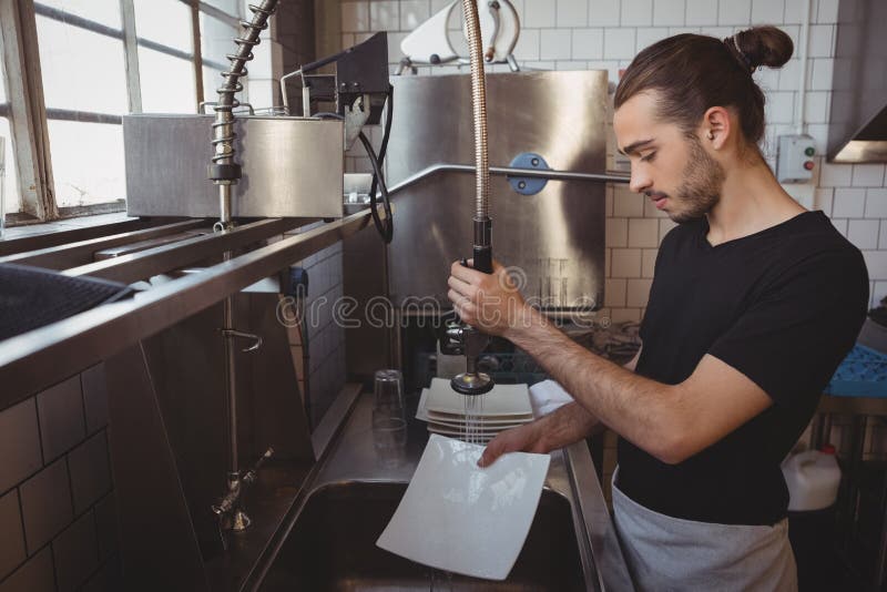 Waiter Washing Plates in Cafe Stock Photo - Image of holding ...