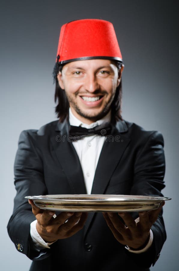 Waiter wearing traditional stock photo. Image of headgear - 44327088