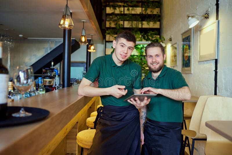 Waiters, Bartenders Barista Rest with the Tablet in a Break Cafe Stock ...