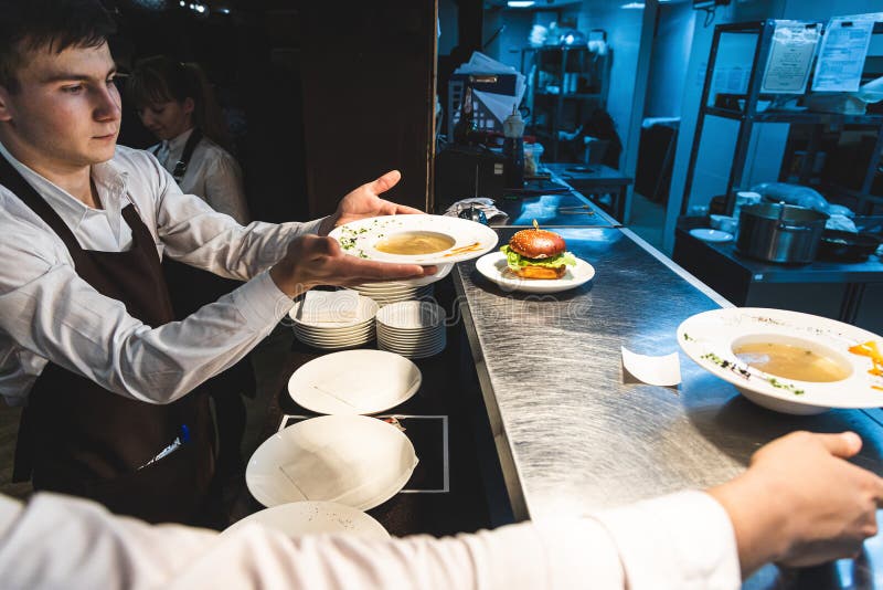 Waiters Pick Up Ready Meals in a Restaurant at the Counter for ...