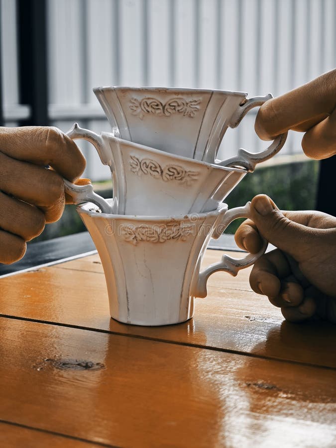Waiters Stacking Teacups on Wooden Table Stock Photo - Image of careful ...