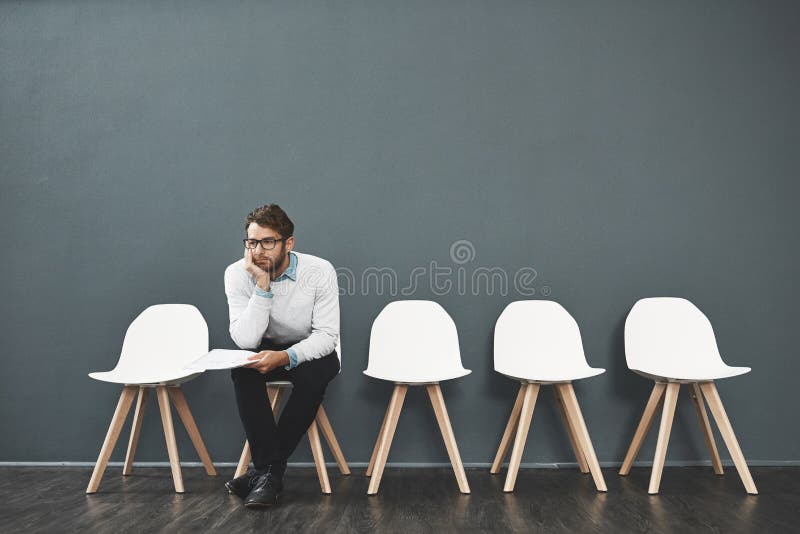 Waiting it Out. a Young Man Waiting in Line for a Job Interview. Stock ...