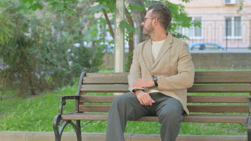The Waiting Young Man Checking Time while Sitting Outdoor Stock Video ...