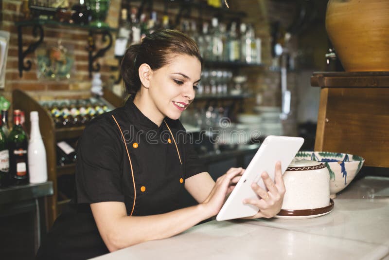 Waitress in Bar with Tablet Looking Orders Stock Photo - Image of ...