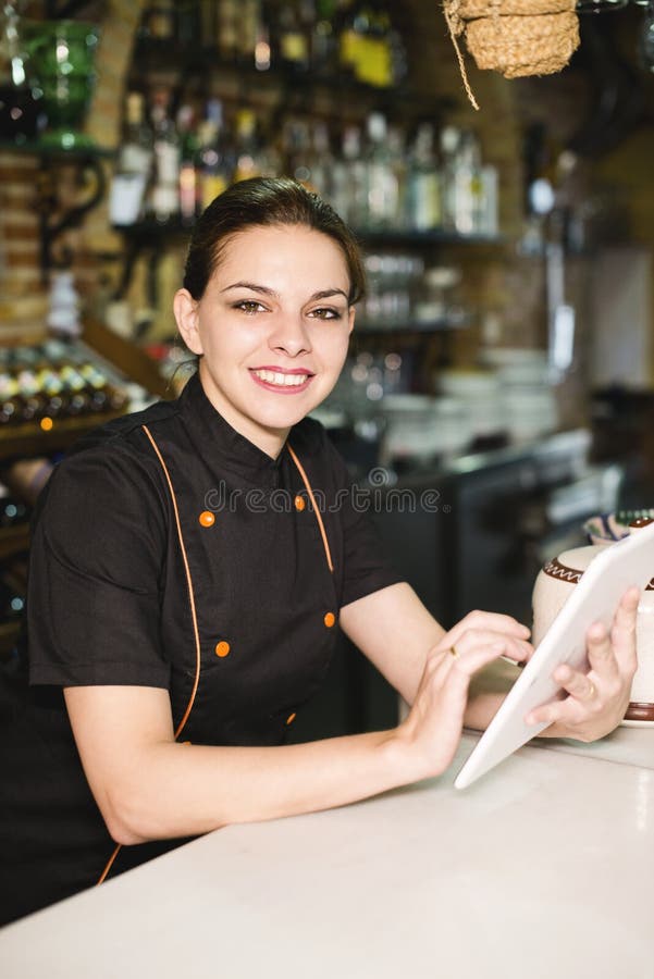 Waitress in Bar with Tablet Looking Orders Stock Image - Image of happy ...