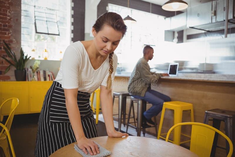 Waitress cleaning table stock image. Image of male, beautiful - 99479461