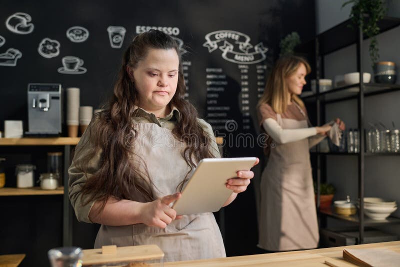 Waitress with Down Syndrome Using Tablet Stock Image - Image of ...