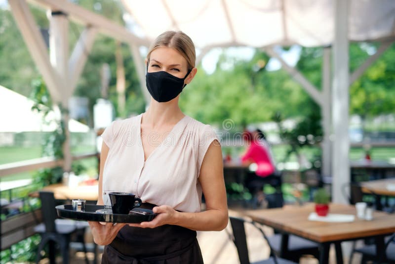 Waitress with Face Mask Serving Customers Outdoors on Terrace ...