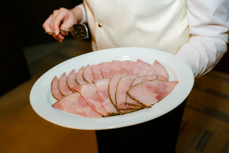 Waitress Hand Offers a Plate of Ham Stock Photo - Image of meat, hand ...