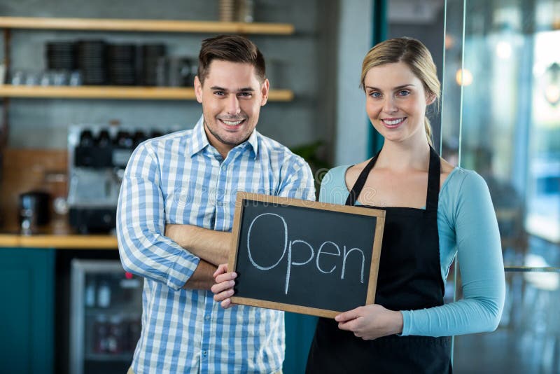 Waitress and Man Standing with Open Sign on Slate in Cafe Stock Photo ...