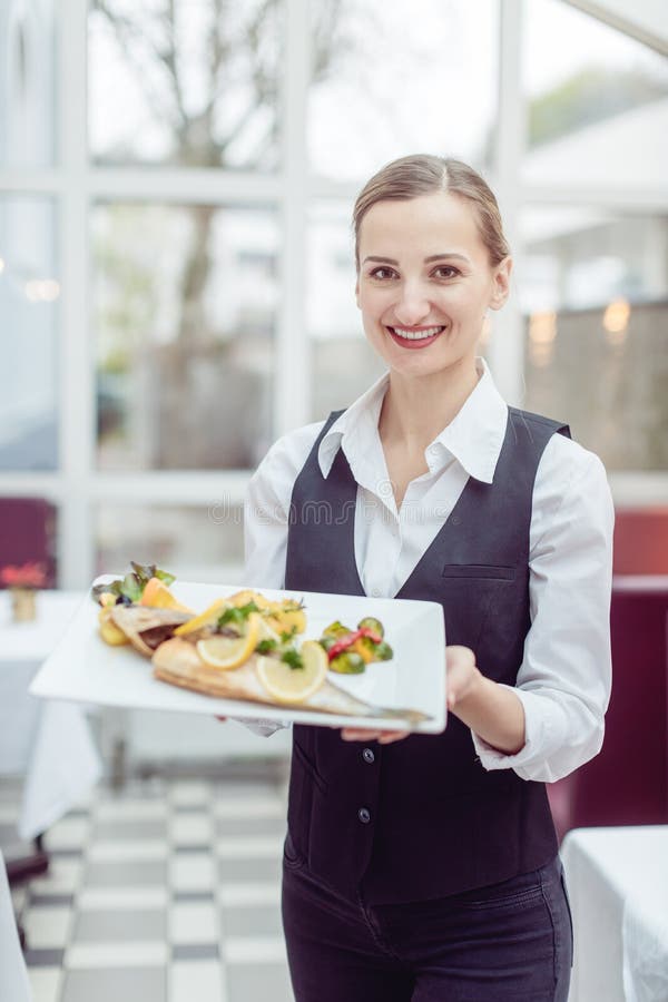 Waitress in a Nice Restaurant Presenting a Tasty Dish Stock Image ...